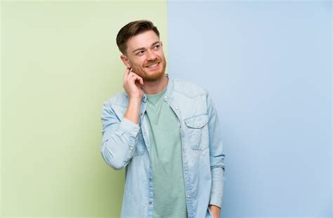 Premium Photo Redhead Man Over Colorful Wall Thinking An Idea