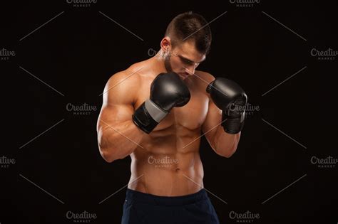 Muscular Young Man With Perfect Torso With Six Pack Abs In Boxing