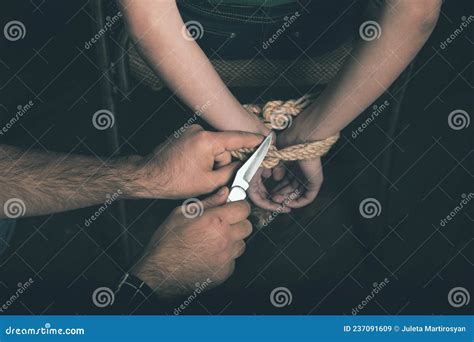 A Man Frees A Tied Woman With A Knife Stock Image Image Of Hostage