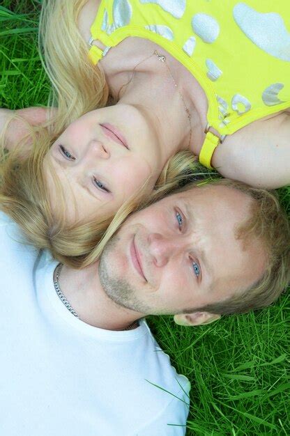 Premium Photo Couple Man And Woman Lie On Green Grass