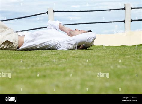 Man Lying On His Back On Grass Stock Photo Alamy