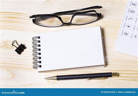 A Clean Notebook With A Pen Is Lying On A Wooden Office Table Top View