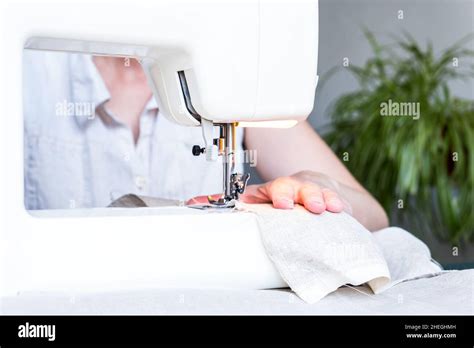 Woman Sewing While Sitting At Her Working Place In Home Sewing Process Female Hands Behind