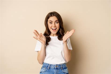 Premium Photo Portrait Of Happy Young Woman Rejoicing Clapping Hands