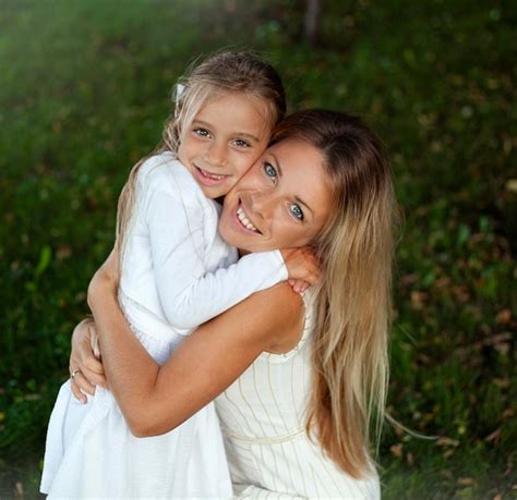 Portrait Of A Happy Mother And Daughter Hugging In The Park Premium
