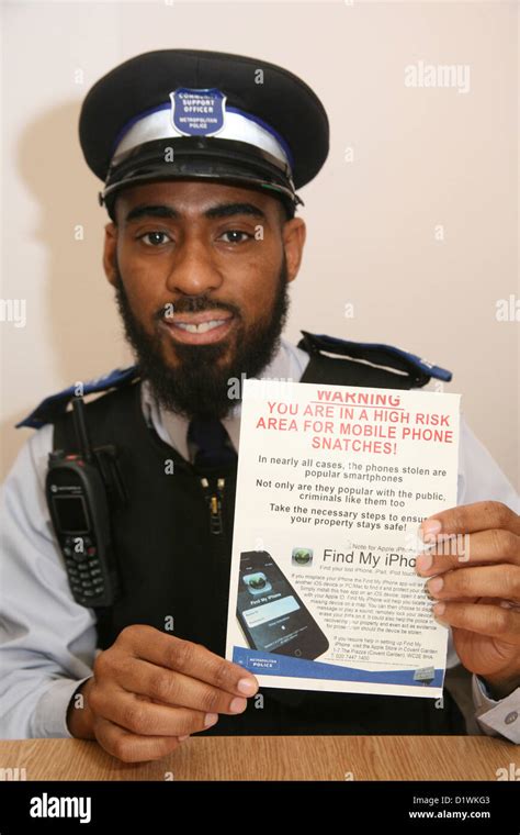 Community Police Officer Displaying Advice Leaflet On Crime Prevention