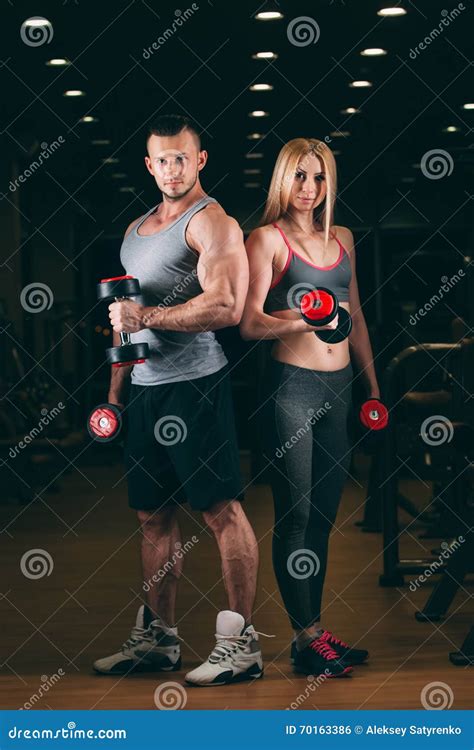 Beautiful Young Sporty Couple Showing Muscle And Workout In Gym