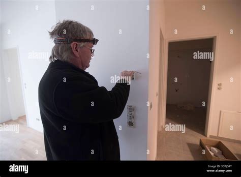 An Electrician Installing Or Repairing Electric And Pulling Cables In A Building An Electrician