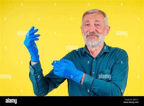 Portrait Of A Man With Towel And Spray Ready To Clean Windows In Studio Portrait Of A Man With Towel And Spray Ready To Clean Windows In Studio
