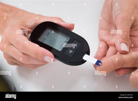 Close Up Of Doctor Measuring Sugar Reading Of Patient With Glucometer Stock Photo Alamy