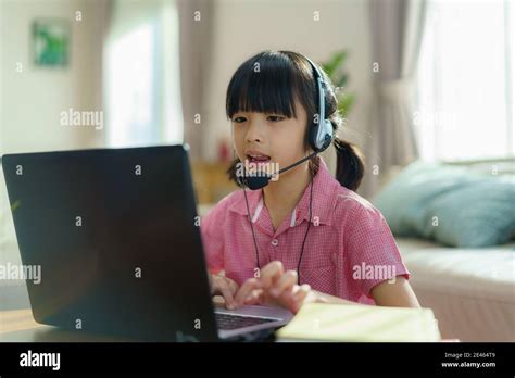 Asian Girl Babe Video Conference E Learning With Teacher And Classmates On Computer In Living