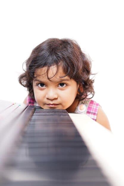 Premium Photo Portrait Of Girl Playing Piano Against White Background