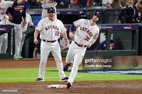 First Base Coach Omar Lopez And Kyle Tucker Of The Houston Astros