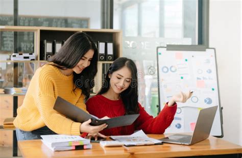 Two Asian Businesswoman Discuss Investment Project Working And Planning