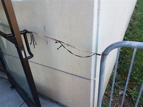 Metal Wire And String Holding Door Open And Cement Wall Stock Image