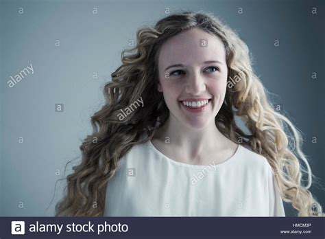 Portrait Smiling Caucasian Young Woman With Long Curly Blonde Hair