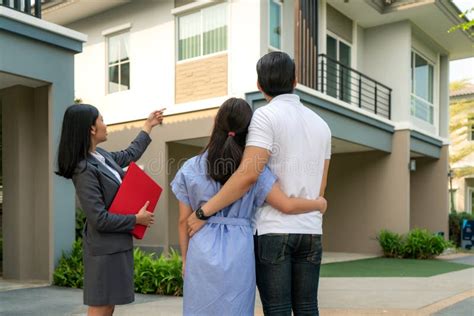 Asian Real Estate Agent Or Realtor Woman Smiling And Holding Red File