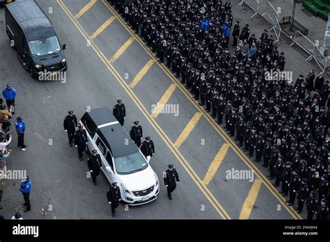 As The Hearse With The Casket Of Nypd Officer Adeed Fayaz Drives By
