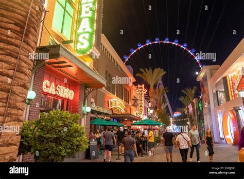 Tourists Exploring Illuminated Linq Promenade In Famous City During