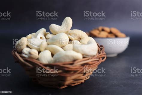 뒤쪽 배경에있는 미니 나무 바구니에 맛있는 캐슈 너트 고안 카주 공간을 복사합니다 건조한 과일 배경 또는 축제 배너 디왈리 선물