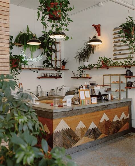 The Interior Of A Coffee Shop With Potted Plants