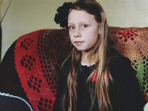 Premium Photo Portrait Of Girl Sitting On Sofa At Home