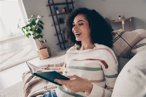 Photo Portrait Of Attractive Young Woman Sit Sofa Hold Book Laugh Have