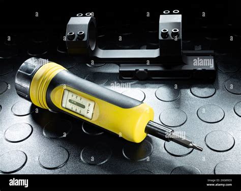 Torque Tool That Measures In Inch Pounds Next To A Large Base For