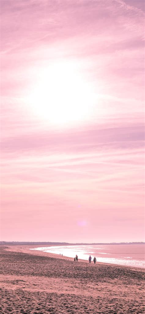 People Walking Along Seashore During Golden Hour Iphone Wallpapers Free