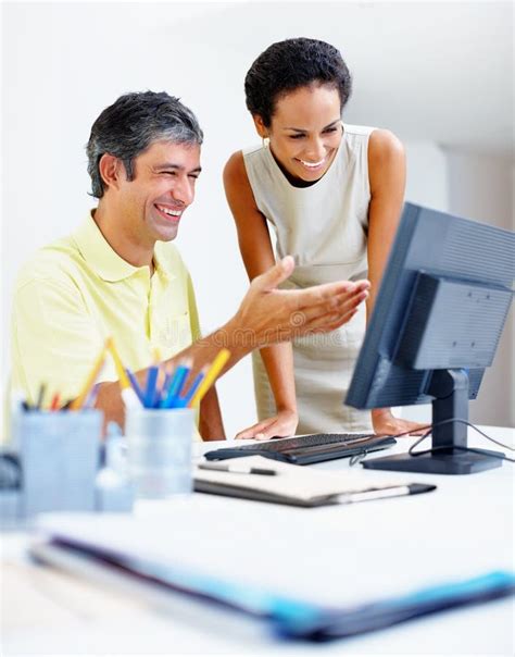 business man working on computer with colleague smiling business man
