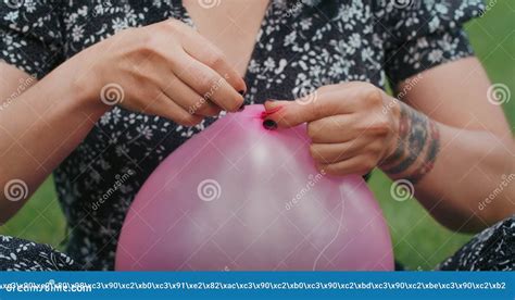 A Happy Woman Inflates Balloons And They Burst Showing That Everything