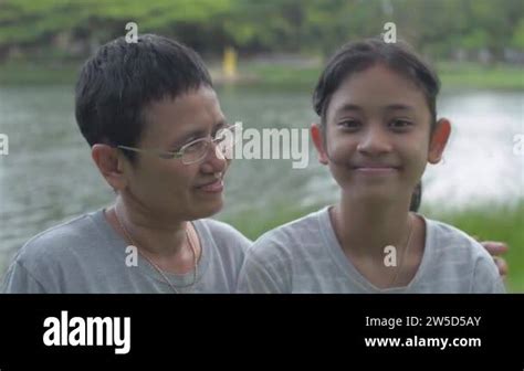 Portrait Happy Asian Single Mom Wears Eyeglasses Posing Closely With
