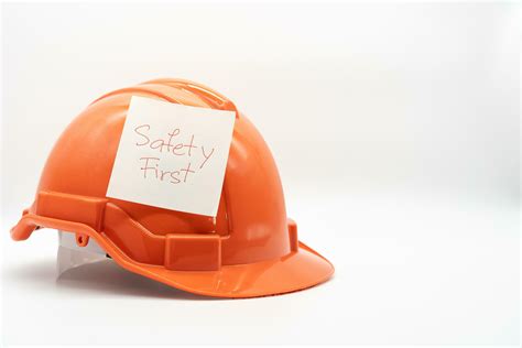 Orange Safety Hat With Message Safety First Hard Hat Isolated On White
