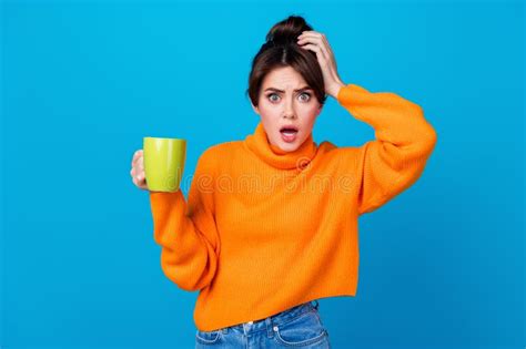 Photo Of Impressed Shocked Woman Dressed Orange Sweater Drinking Tea