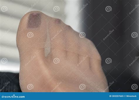 Closeup Of A Woman S Feet In Tan Stockings With Pedicure Stock Image