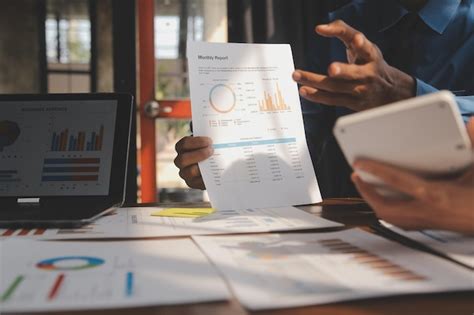 Premium Photo Close Up Of Business Team Analyzing Income Charts And