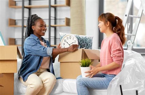 Women Unpacking Boxes And Moving To New Home Stock Image Image Of