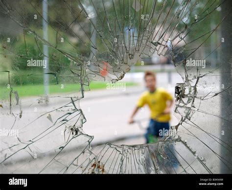 Broken Window With Blurred Babe On Bicycle Behind It Vandalism Hole Stock Photo Alamy