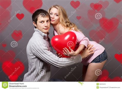 Two Young People Holding Heart Shaped Balloon Stock Image Image Of
