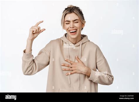 Image Of Young Woman Pinching Fingers Holding Something Small Or Tiny Laughing Of Size