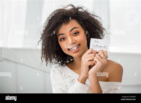 Cheerful African American Girl In Braces Holding Card With I Am