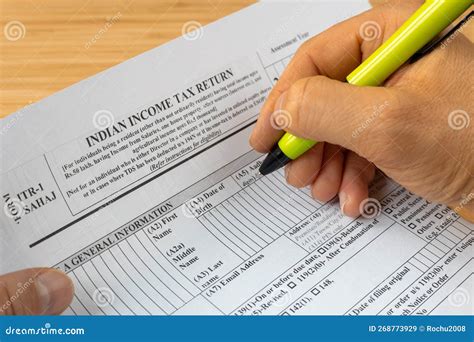 Income Tax Return In India ITR Form And Hand With Pen Of The Person Completing The Returns
