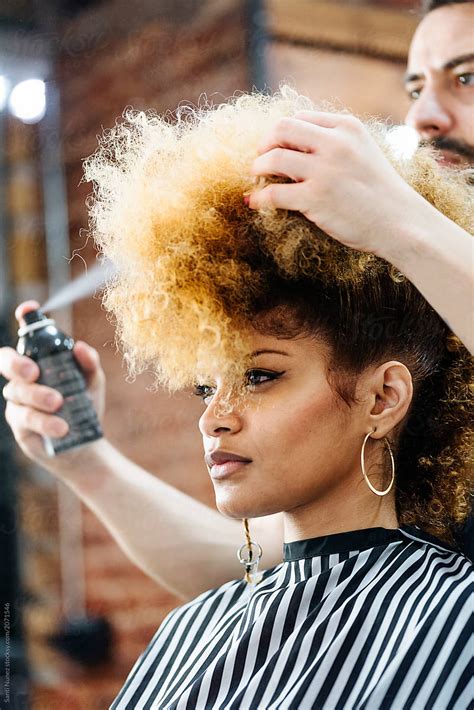 Beautiful Afro Woman Getting Haircut By Hairdresser In The Beauty