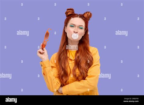 Portrait Of Beautiful Woman With Bright Makeup Blowing Bubble Gum On