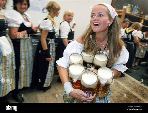 Singer And Waitress Barbara Babsi Stadlhuber Passes Her Colleagues As She Carries Beer Mugs In