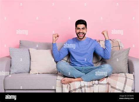 Photo Of Shiny Lucky Arab Guy Dressed Blue Pullover Sitting Couch