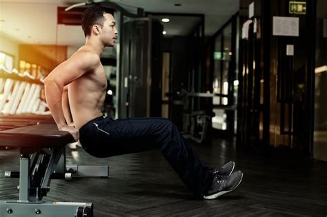 Premium Photo Muscular Man Doing Push Up On Chair
