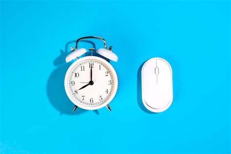 Free Photo Alarm Clock And Computer Mouse On A Blue Background