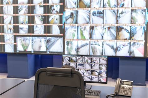 Security Control Room With Surveillance Monitors And Security Officer Monitoring Multiple Cctv