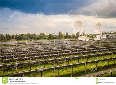 Large Scale Solar Farm With The Satellite Dishes Under Dramatic Stock